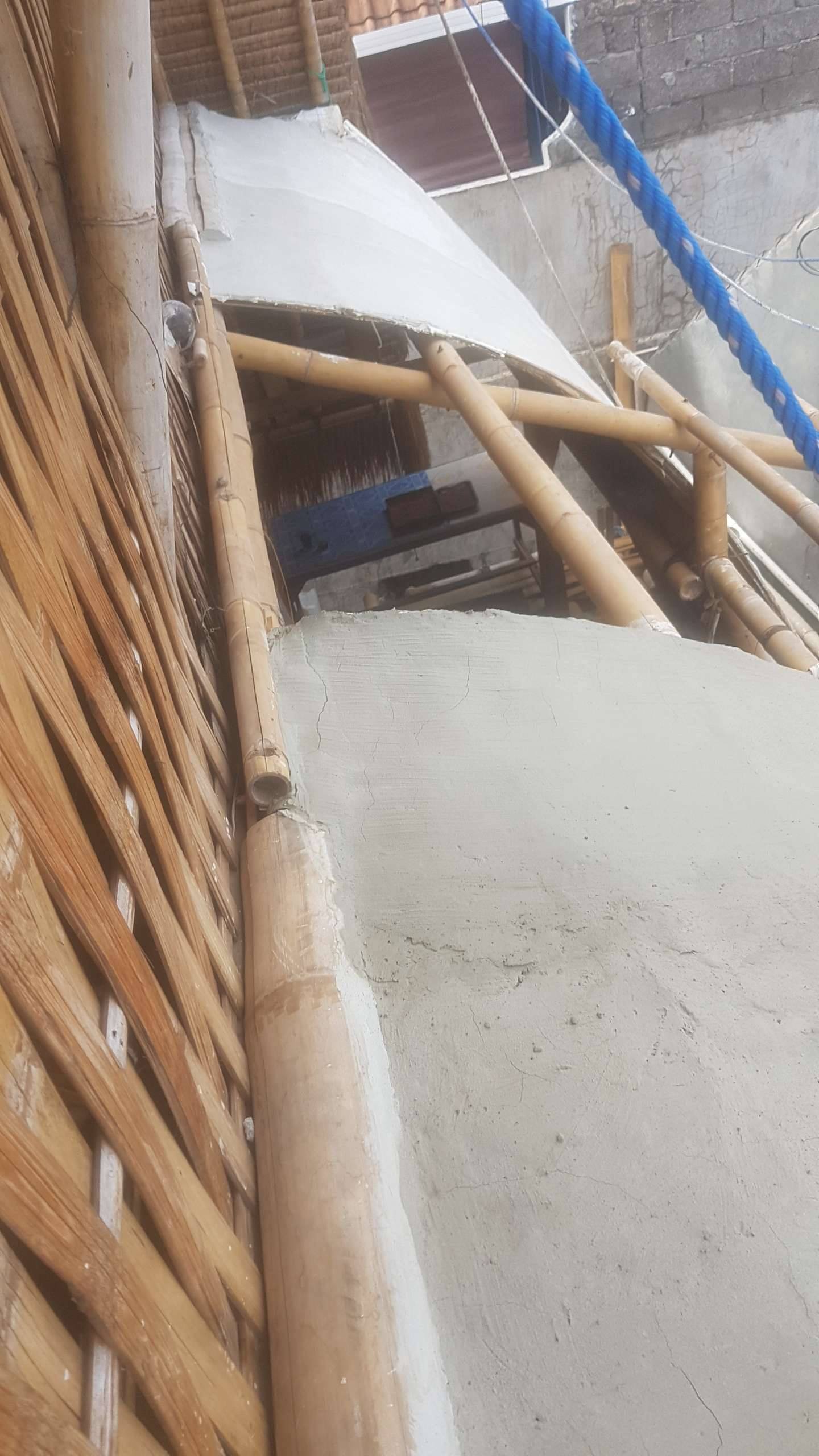 Plastering ‘Bedek’ bamboo woven panel roof with cassava flour glue and ...